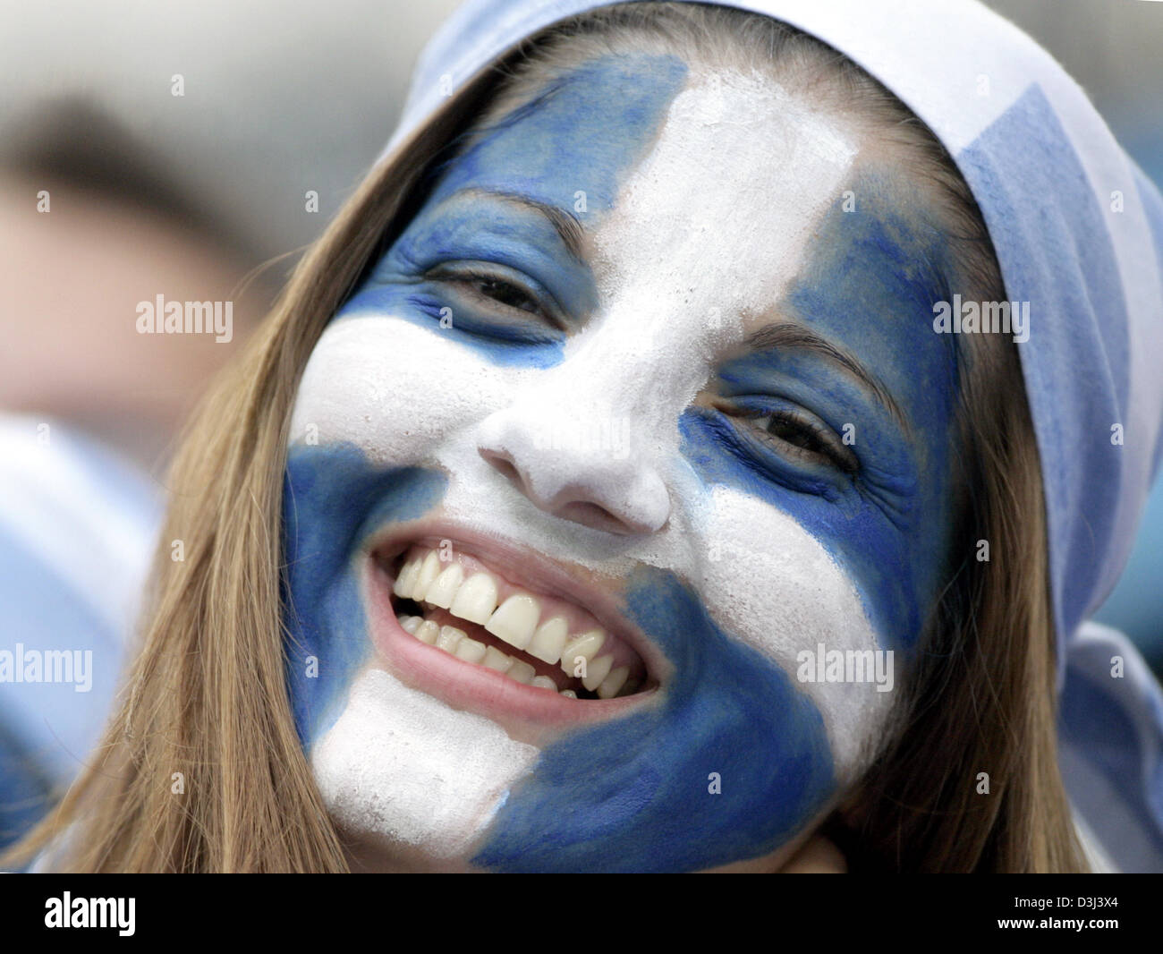 (dpa) - The picture shows a female greek fan with a painted face prior ...