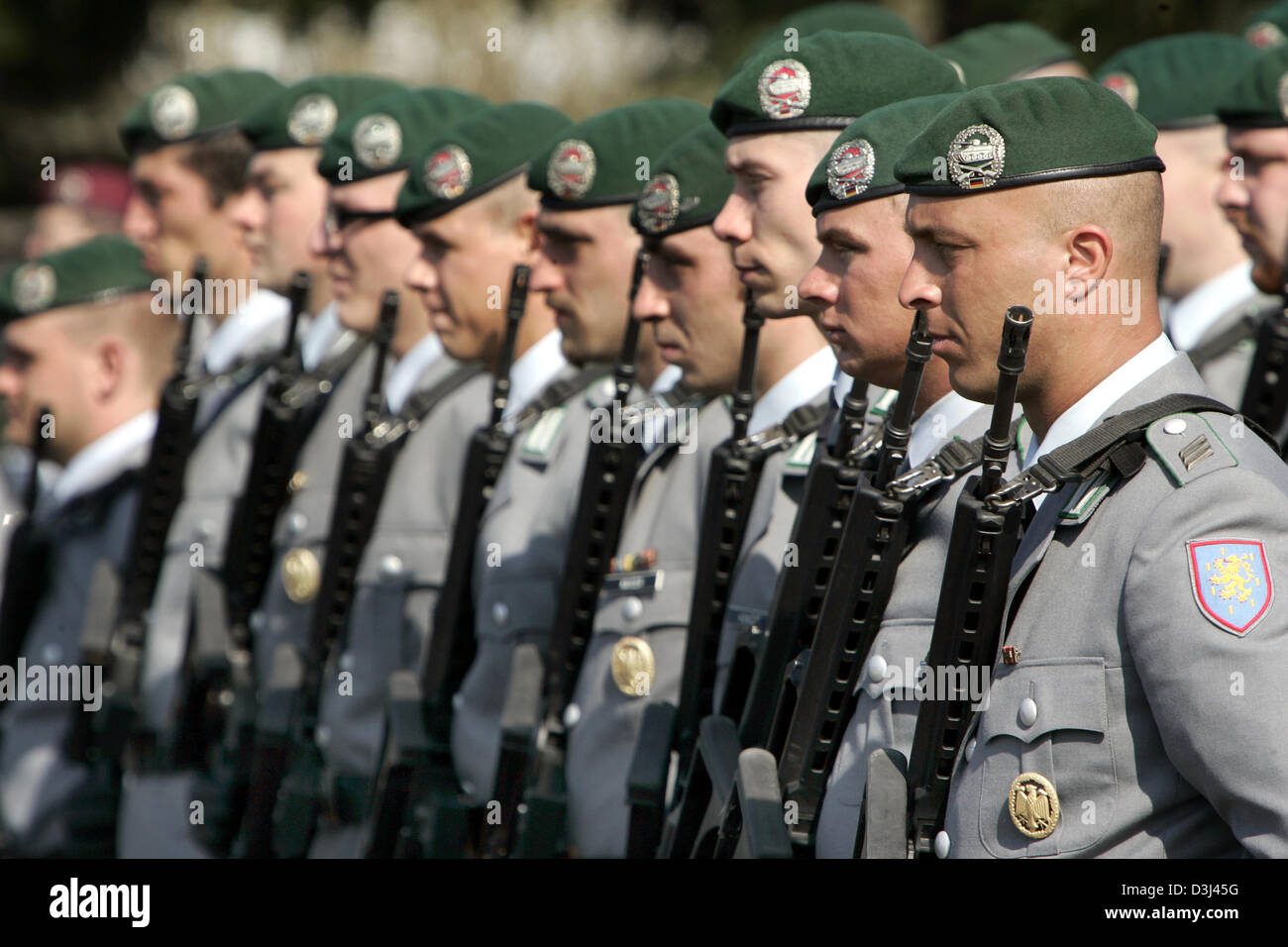 (dpa) - German Bundeswehr soldiers pictured with their weapons during a ...