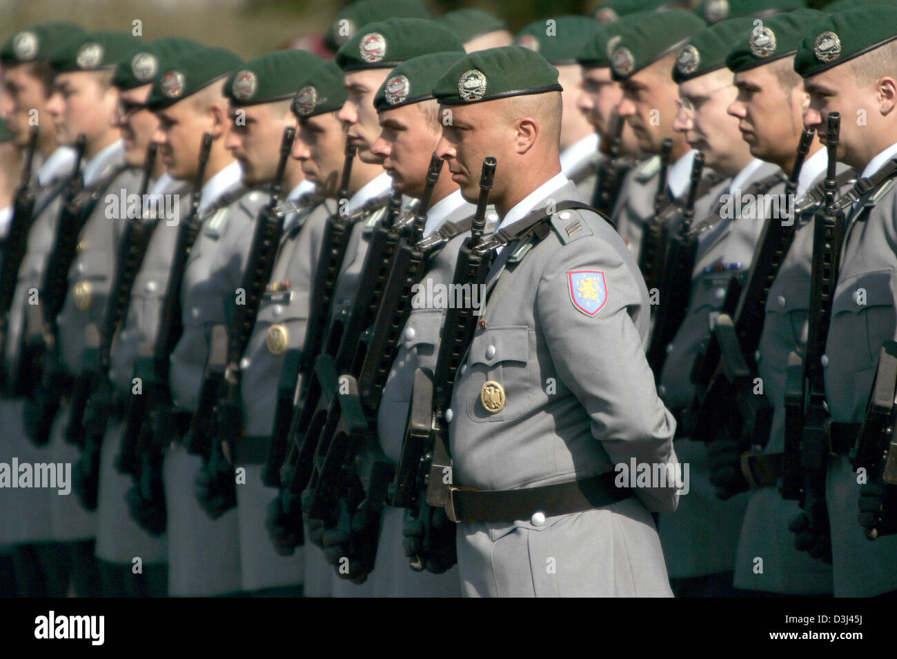 (dpa) - German Bundeswehr soldiers pictured with their weapons during a ...