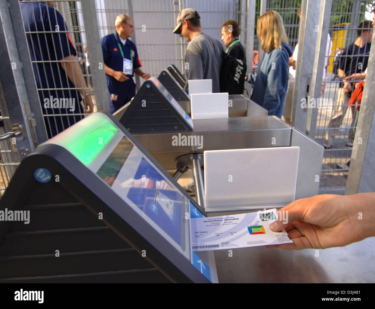 (dpa) - Spectators place their tickets in the digital scanners, which ...