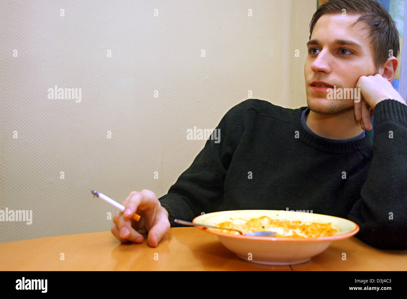 (dpa) - An adolescent smokes a cigarette after his meal pictured in ...