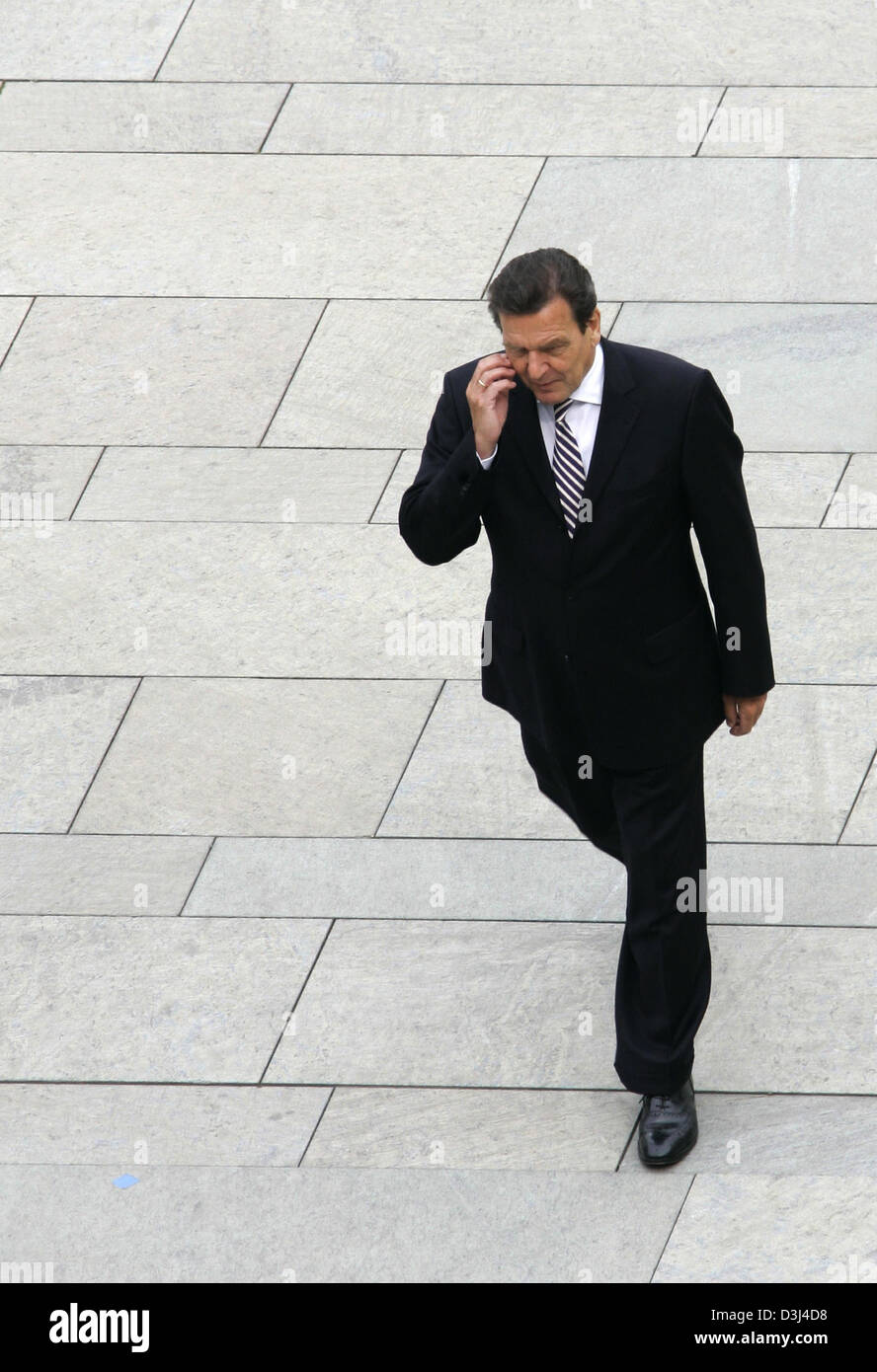 (dpa) - German Chancellor Gerhard Schroeder walks across the courtyard ...