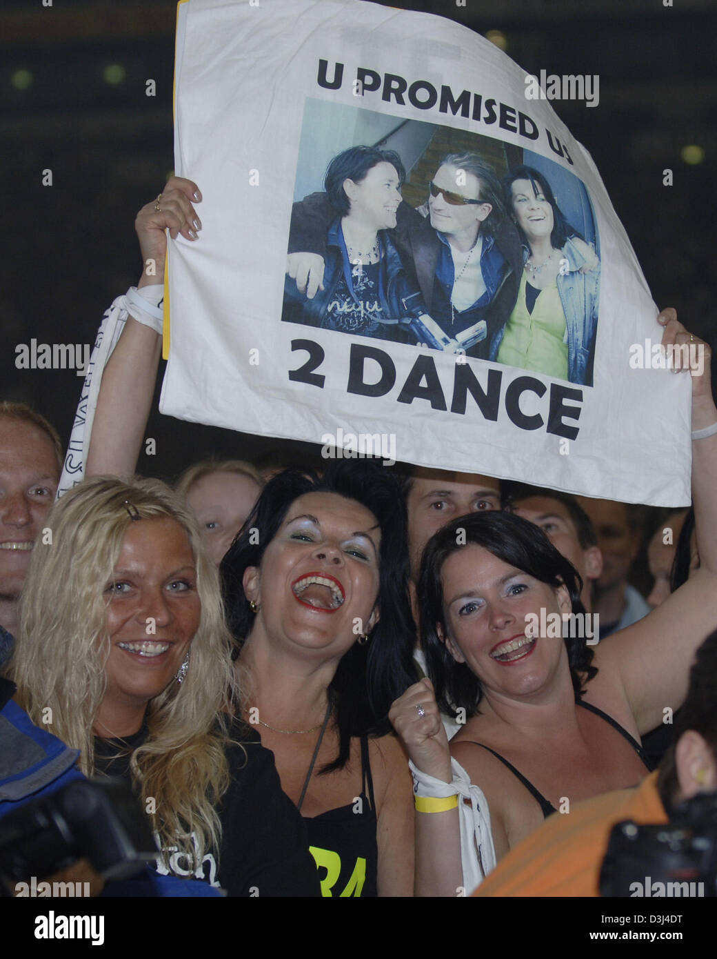 (dpa) - Two fans of the British rock band 'U2' hold up a poster which ...