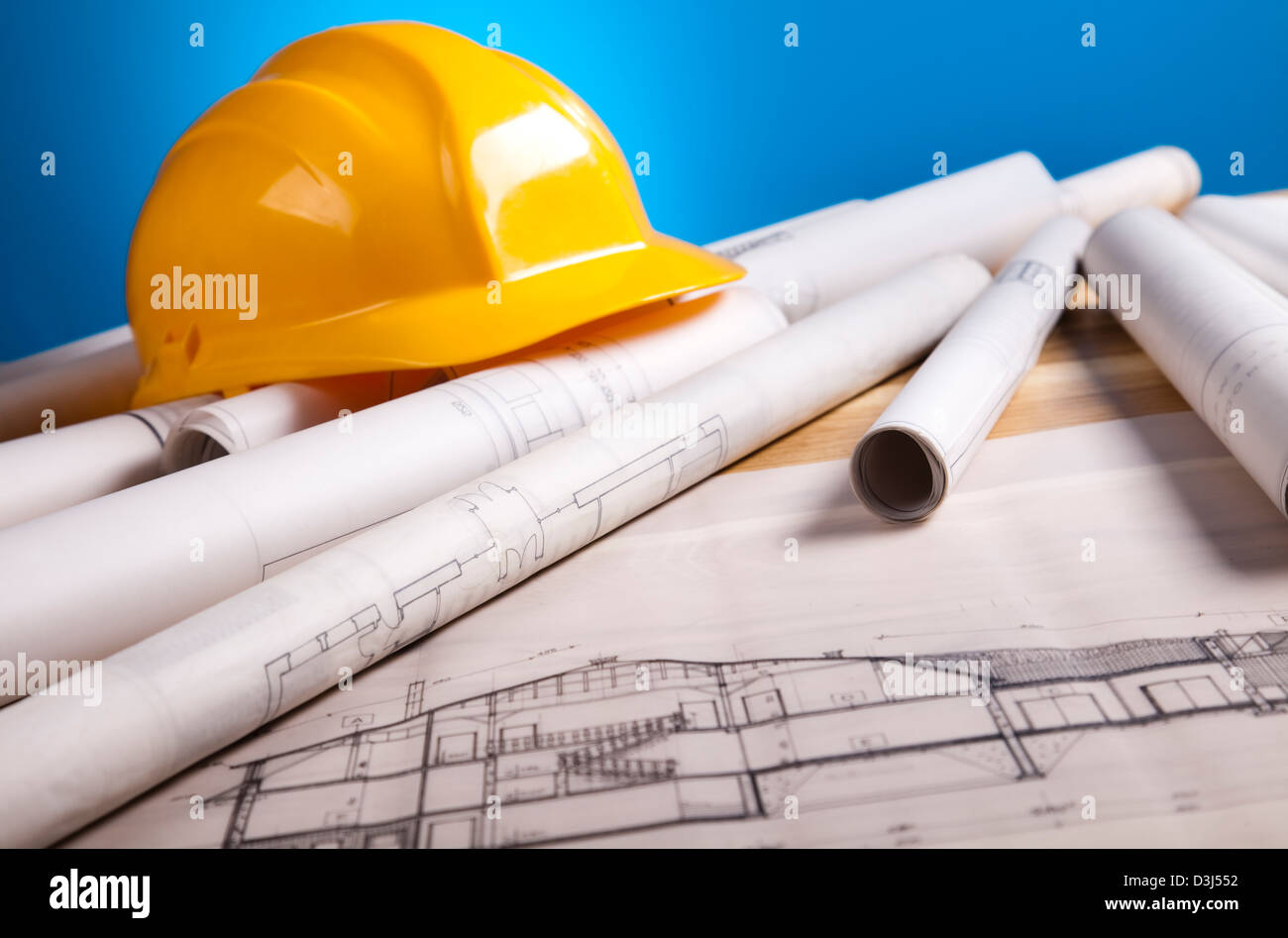 House plan blueprints with yellow hard hat Stock Photo - Alamy