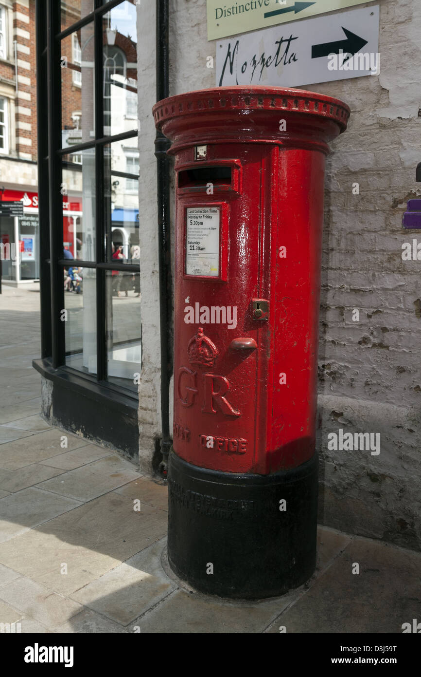 Traditional British red pillar box made from heavy cast iron with the ...