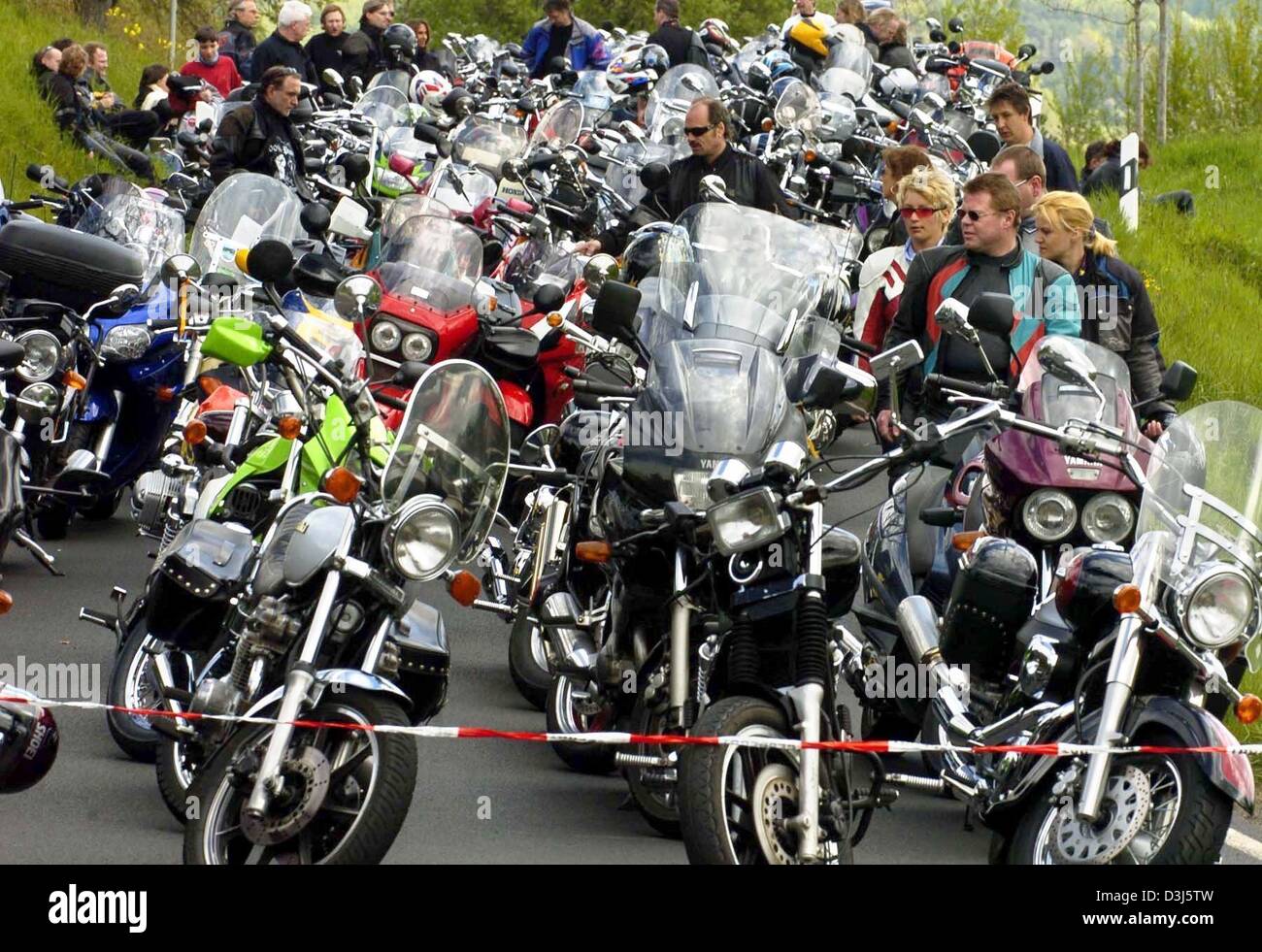 (dpa) - A group of motorcycle enthusiasts walks past the parked bikes ...