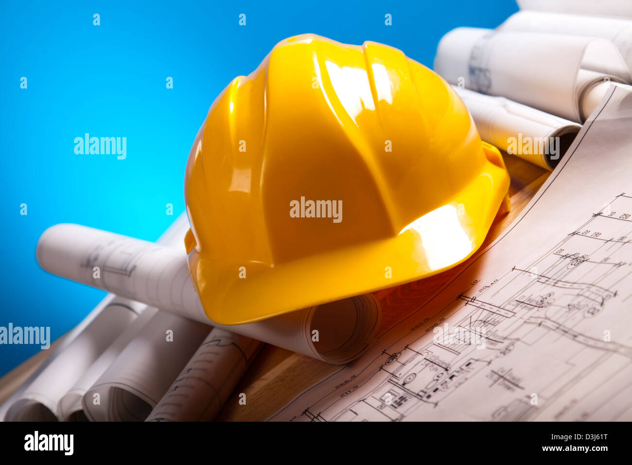 House plan blueprints with yellow hard hat Stock Photo - Alamy