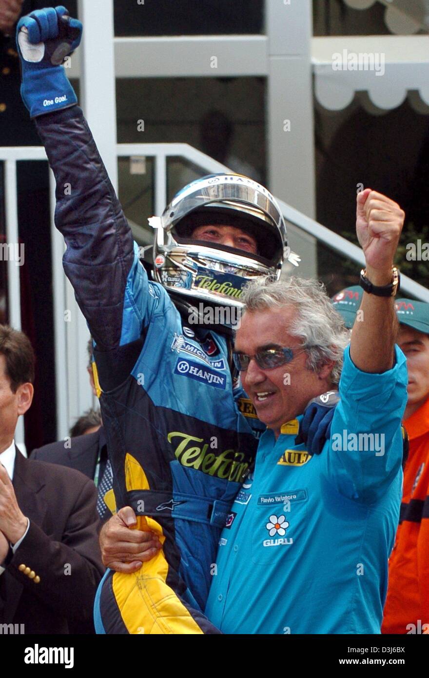 (dpa) - Team leader of Renault, Flavio Briatore (R) cheers and ...
