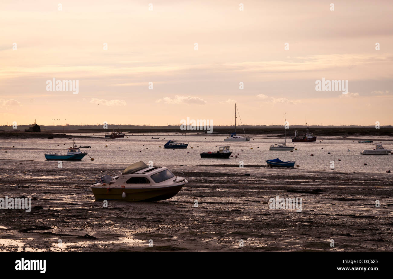 Boats on the mud in West Mersea, Essex Stock Photo - Alamy