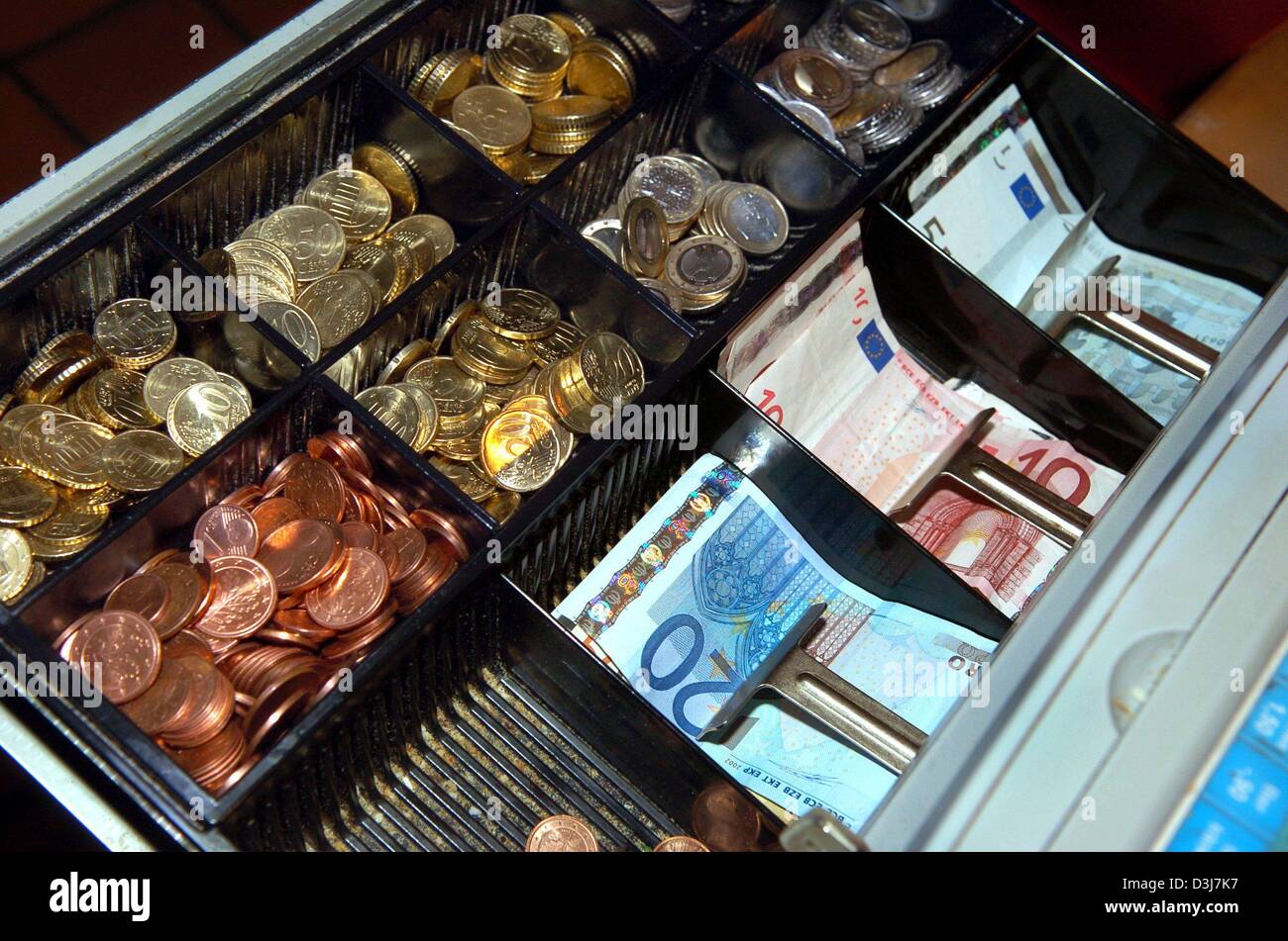 (dpa) - Euro notes and change are seen in a cash register in a shop in ...