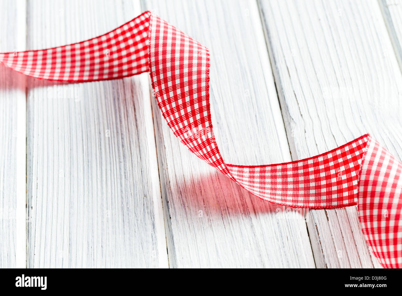 the checkered ribbon on white wooden table Stock Photo - Alamy