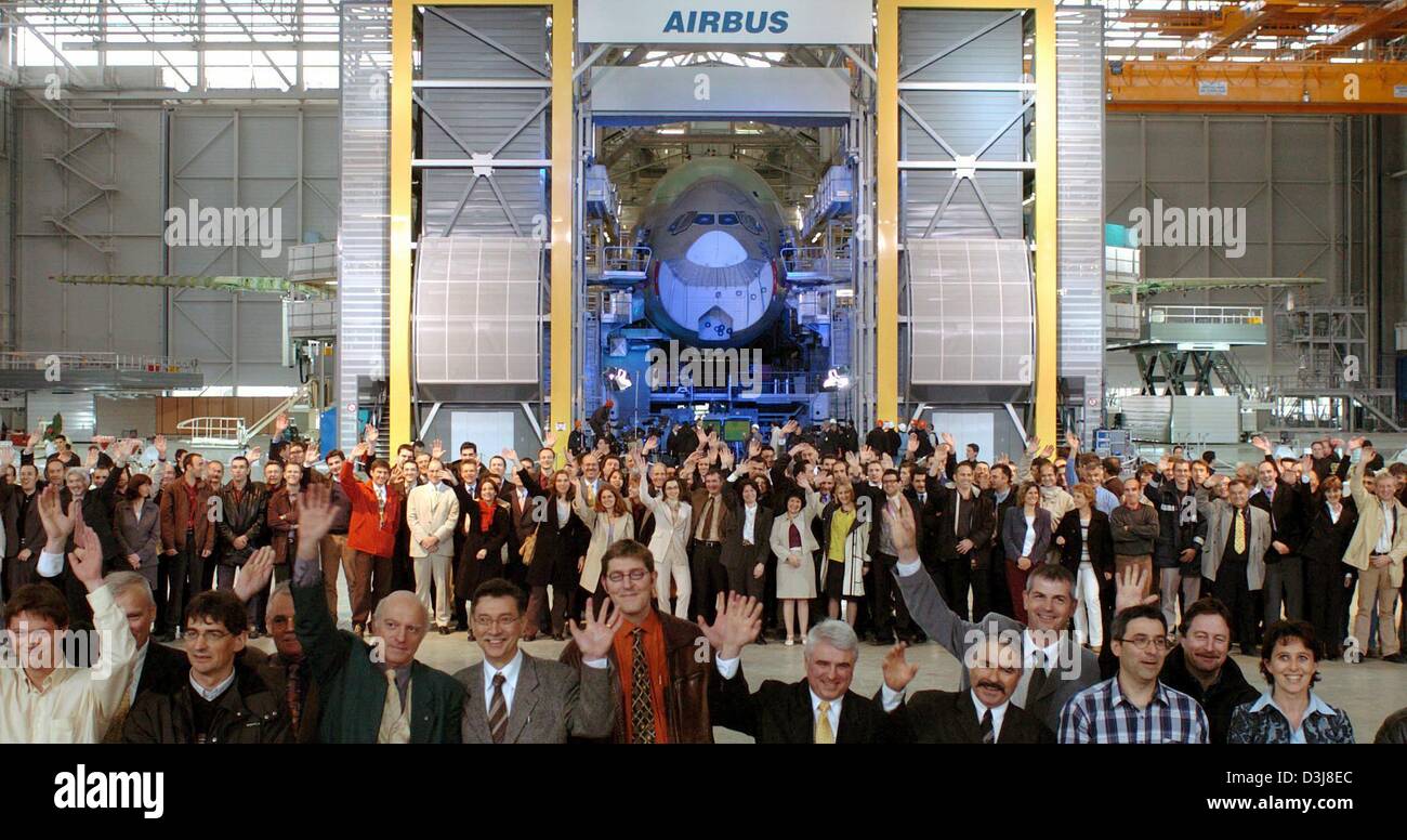 (dpa) - Employees of Airbus cheer and wave their hands shortly after ...
