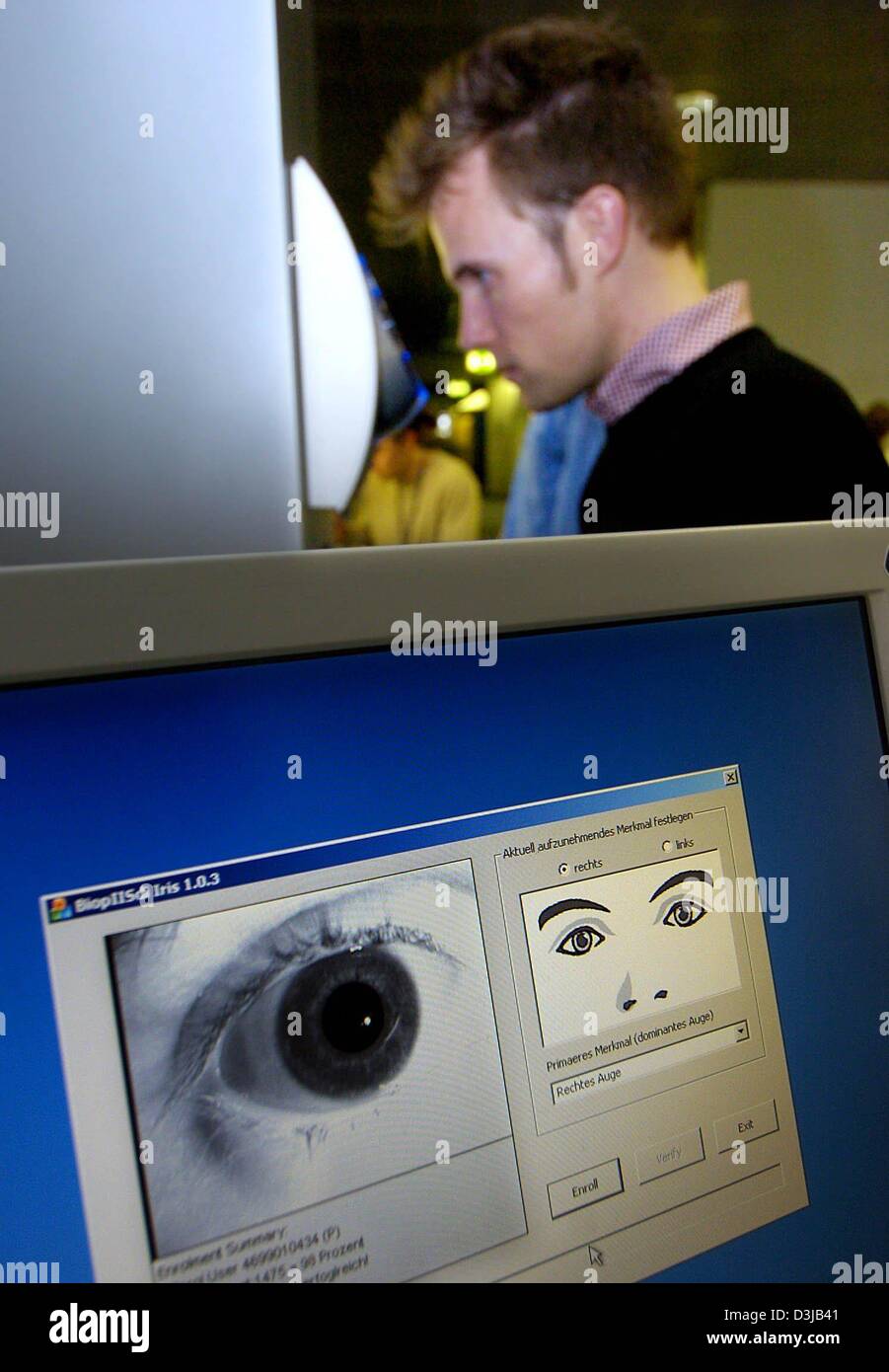 (dpa) - A man stands in front of a biometric scanner which scans his ...