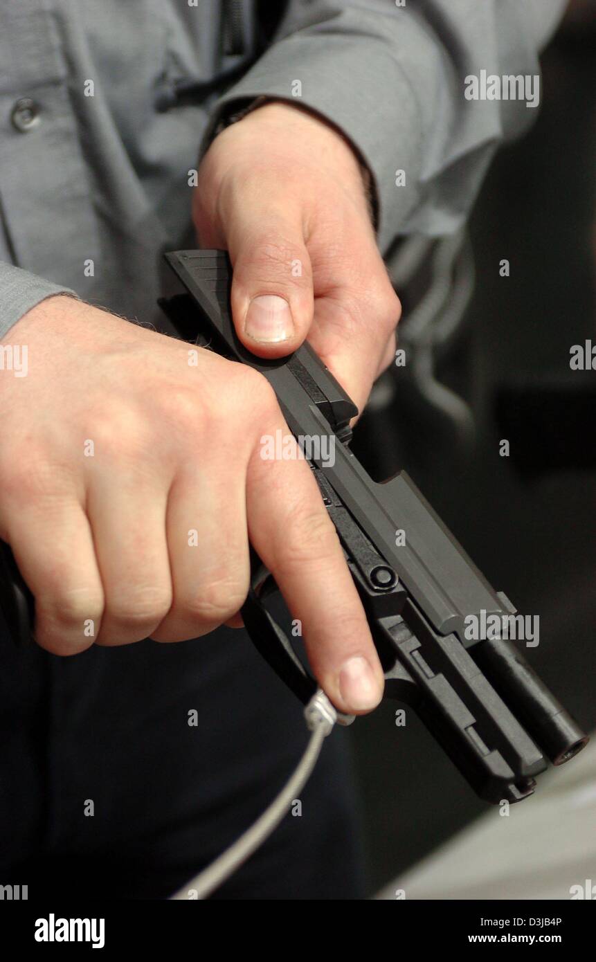 (dpa) A visitor clamps a gun at the Heckler& Koch stand on the 31st ...