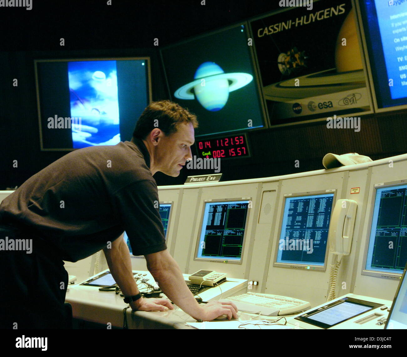 (dpa) - An employee of ESA (European Space Agency) looks at monitors ...