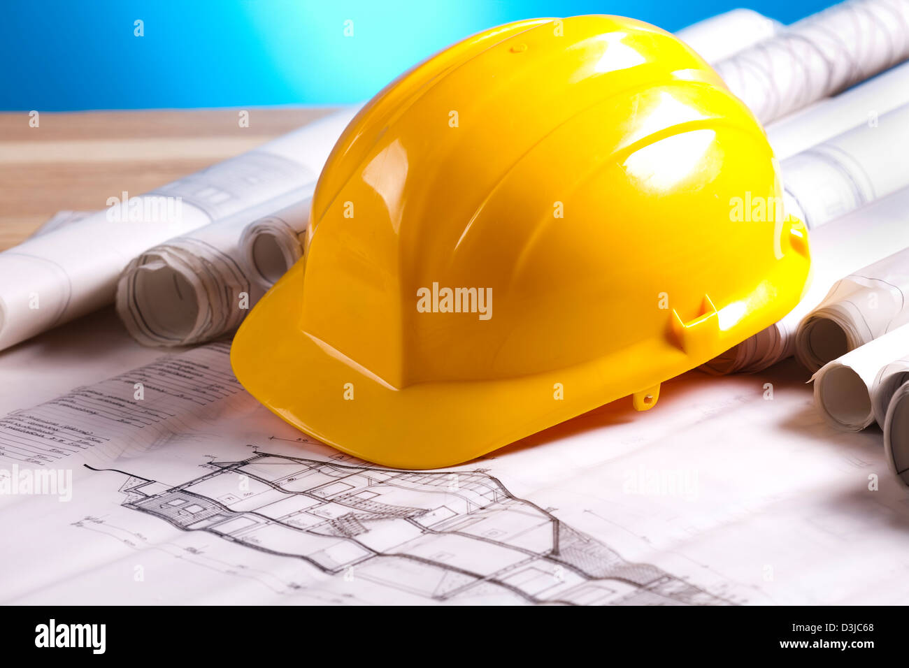 House plan blueprints with yellow hard hat Stock Photo - Alamy