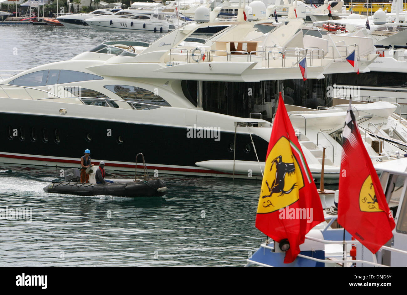 (dpa) - The picture shows Monaco harbour and eFerrari flags on a yacht ...