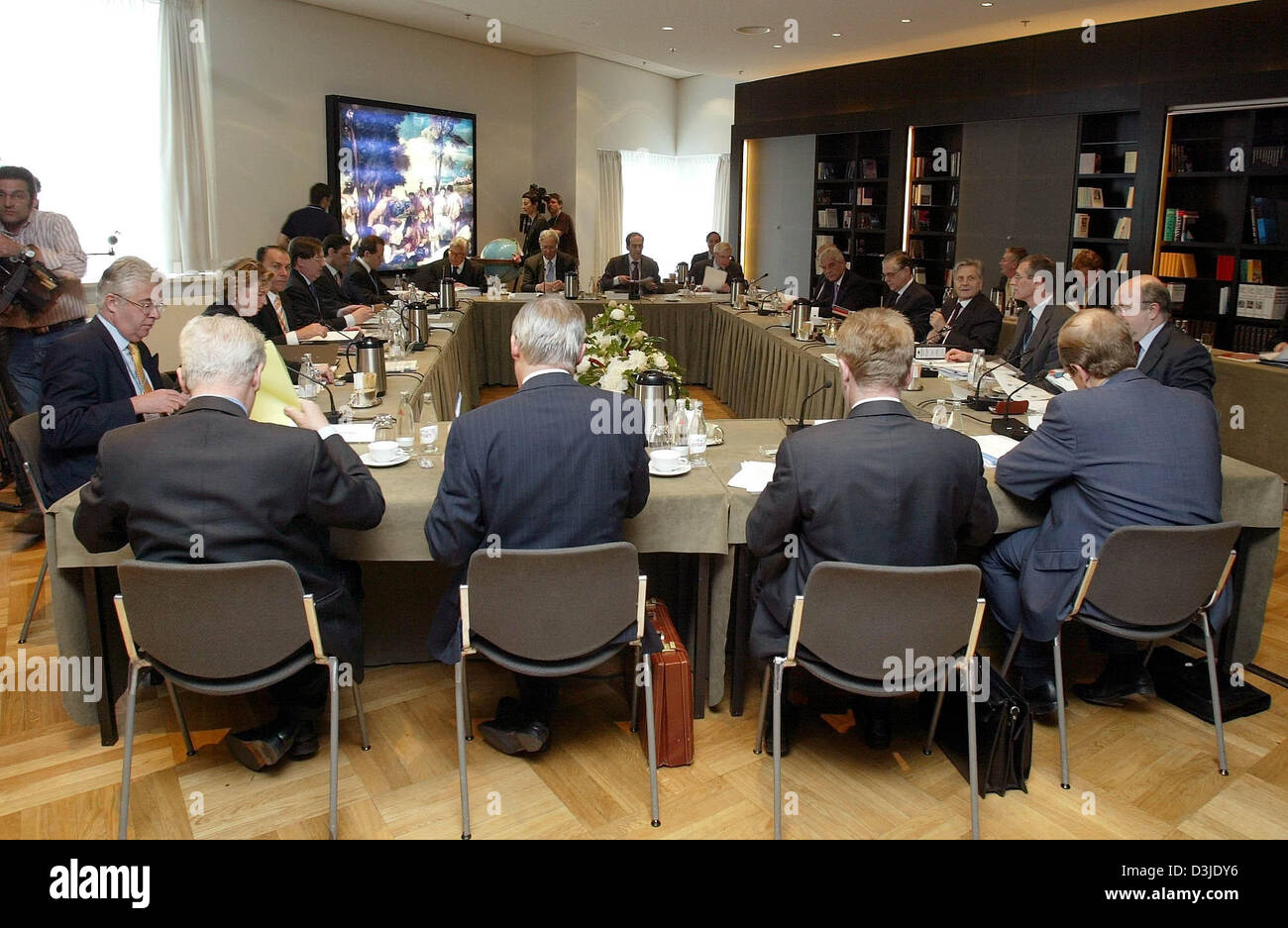 (dpa) - The picture shows the ECB members sitting around a table in a ...