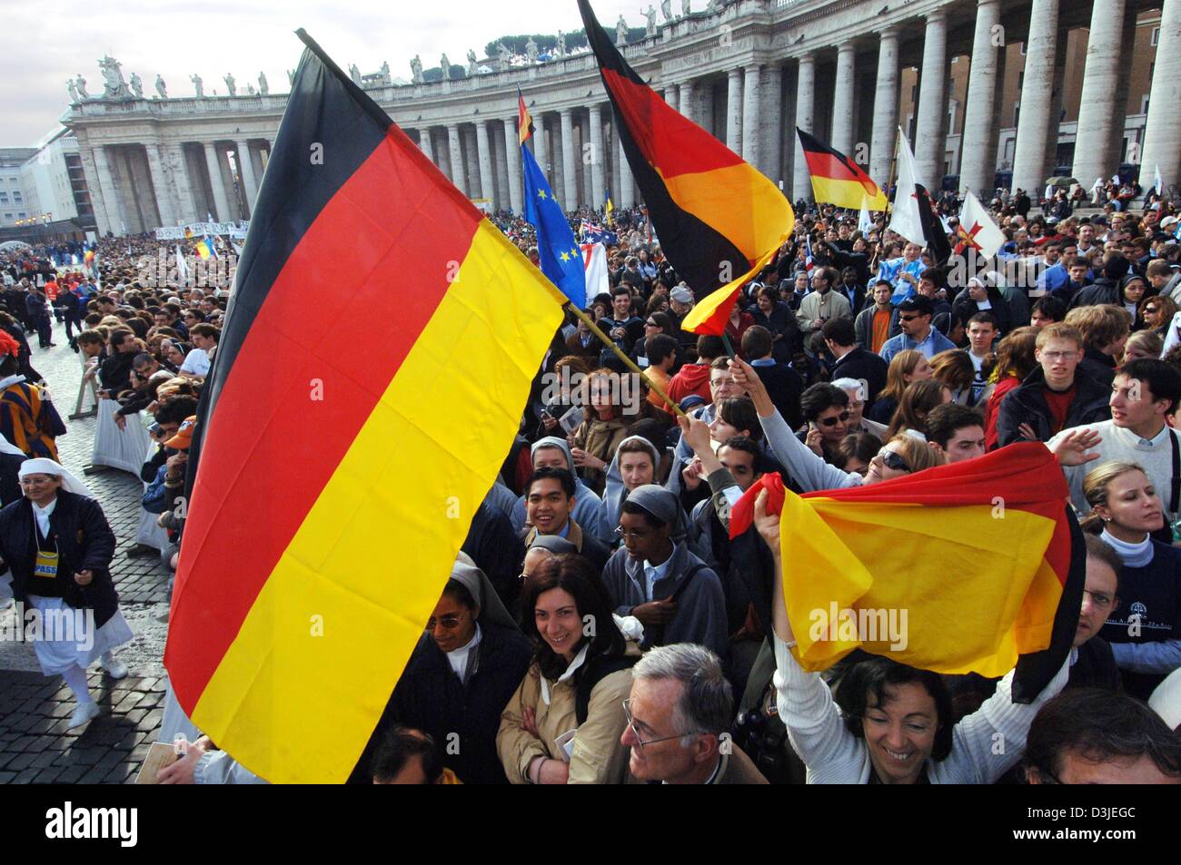 (dpa) - German pilgrims sway their flags during the church service on ...