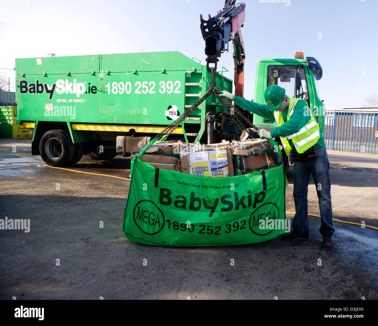 Refuse Collection truck lifting with a hydraulic lift a bag using ...