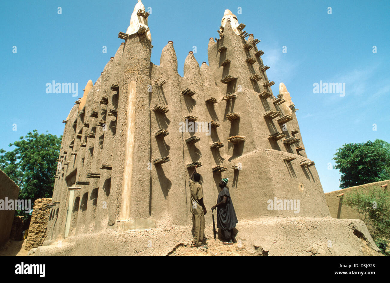 Two men from the Bozo tribe inspecting the traditional adobe mosque in ...