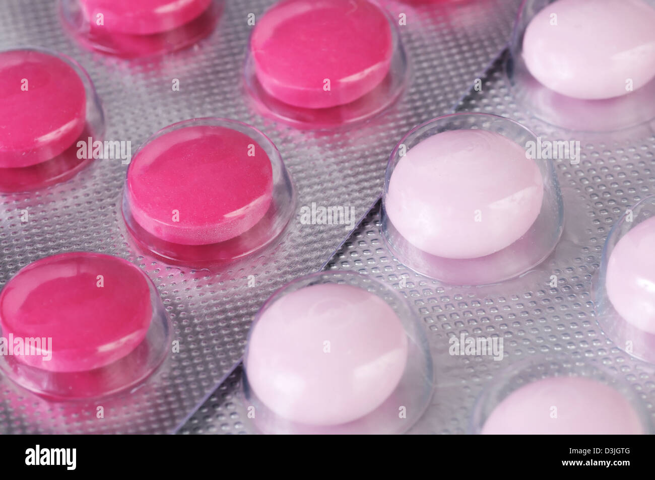 Red and pink tablets in package Stock Photo - Alamy