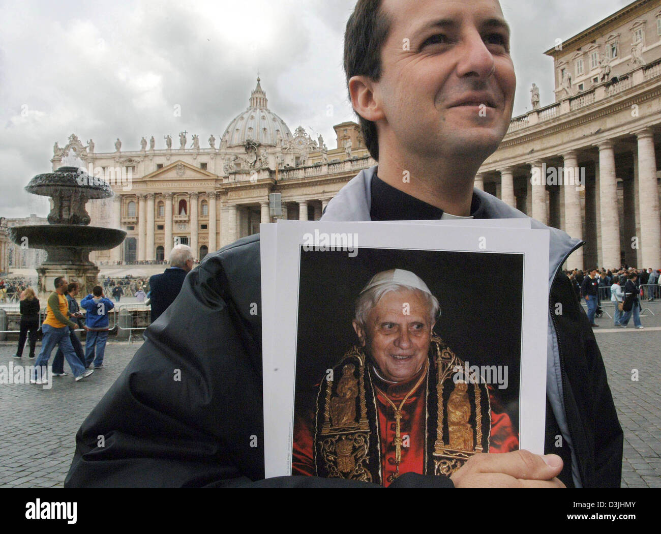 (dpa) - A chaplain carries a picture of newly elected Pope Benedict XVI ...