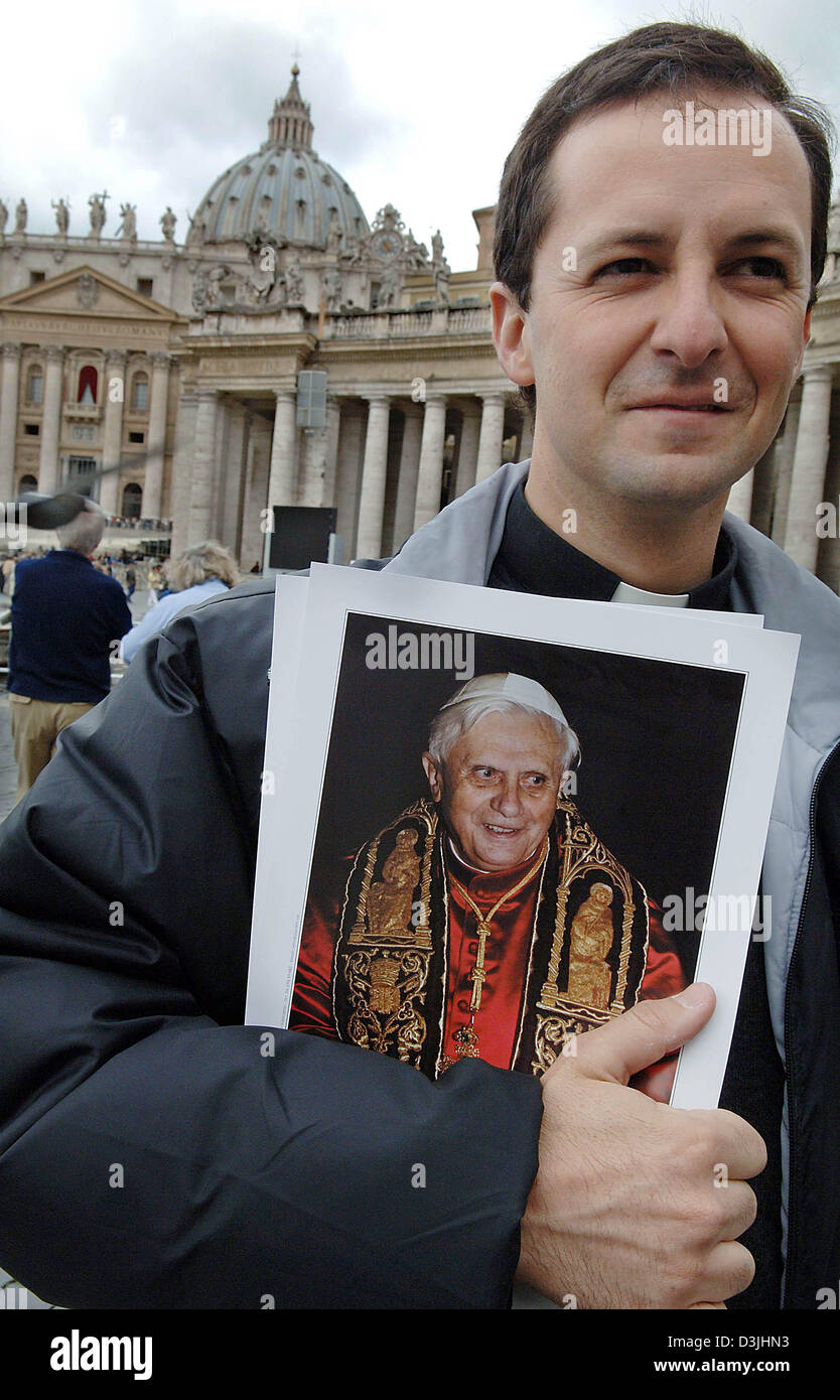 (dpa) - A chaplain carries a picture of newly elected Pope Benedict XVI ...