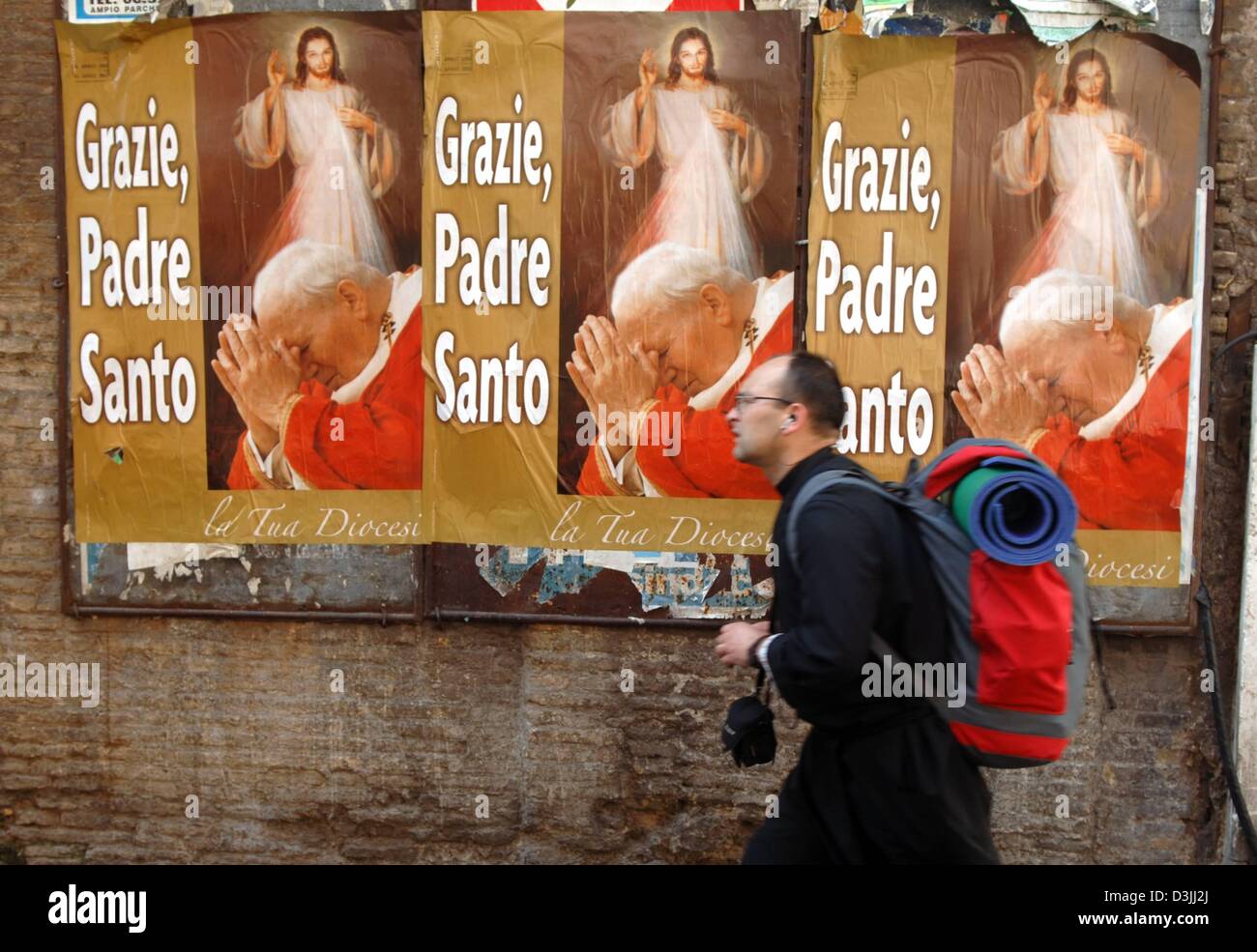 (dpa) - A monk hurries past posters, which thank Pope John Paul II ...