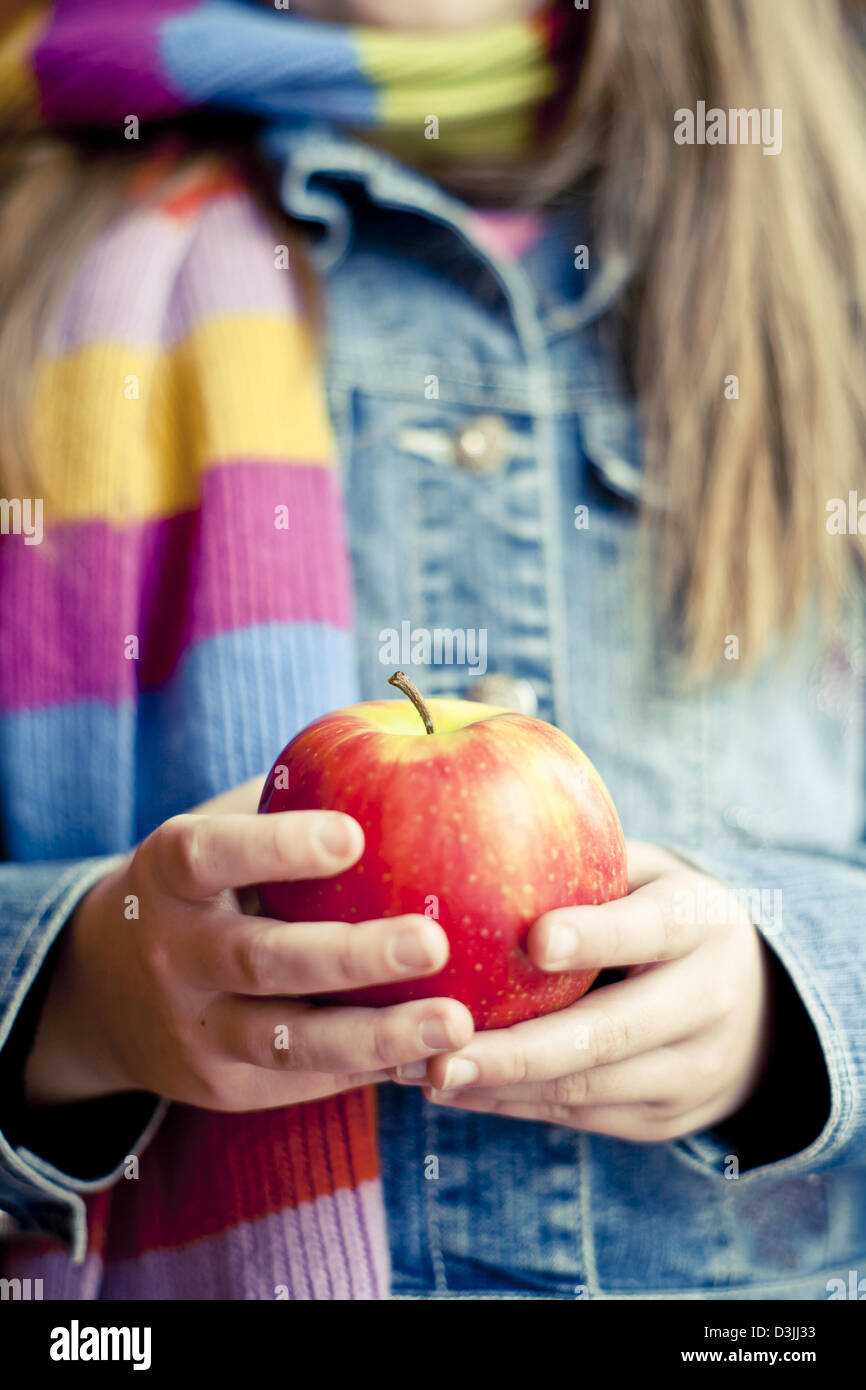 Girl holding an apple Stock Photo - Alamy
