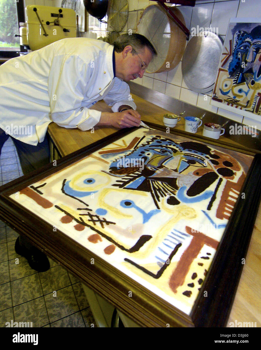 (dpa) - Pastry chef Hanns Wenninger decorates a gateau which features a ...