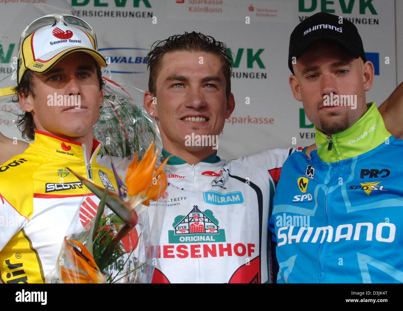 (dpa) - David Kopp (C) cheers and smiles as he stands on the podium ...