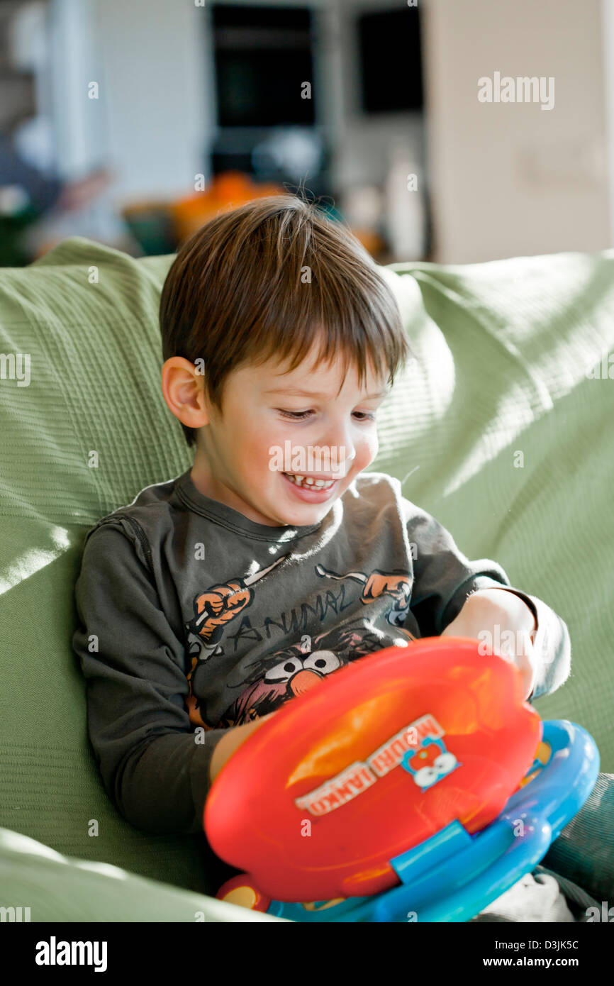 Boy playing with a toy computer Stock Photo - Alamy