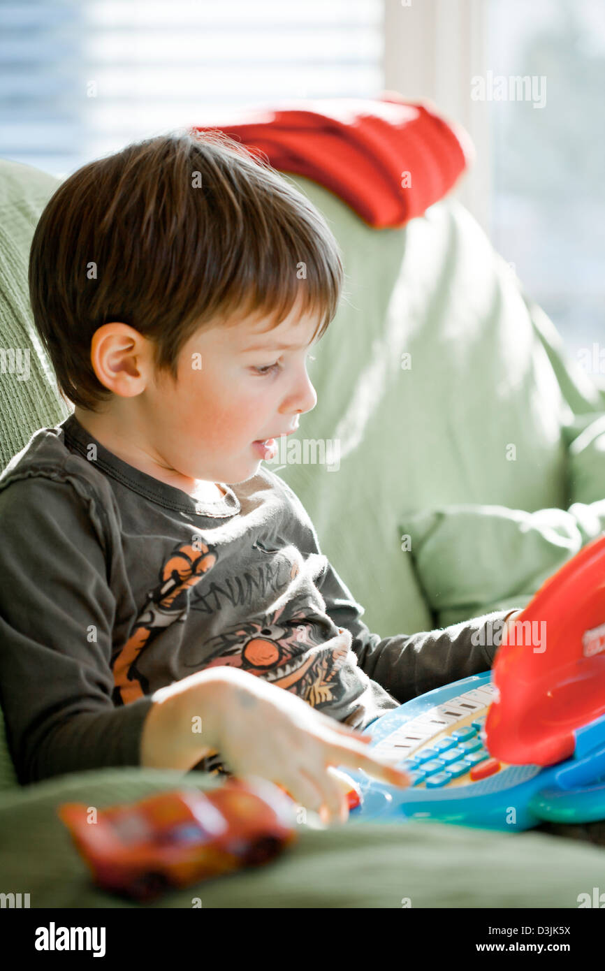 Boy playing with a toy computer Stock Photo - Alamy