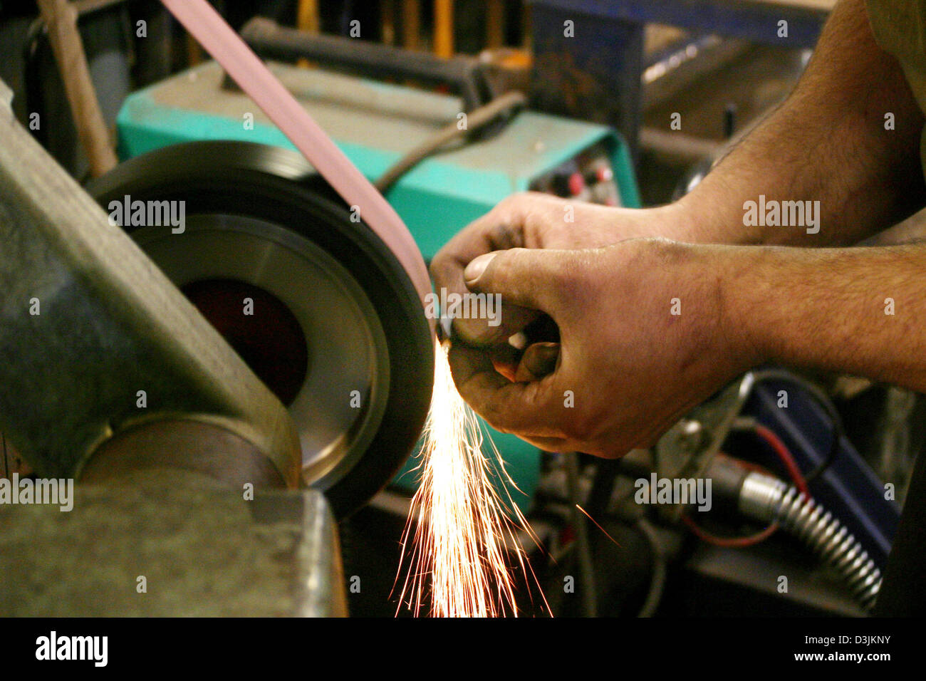 (dpa) - A man works at a grinding wheel in the Jenauth/Luest blacksmith ...
