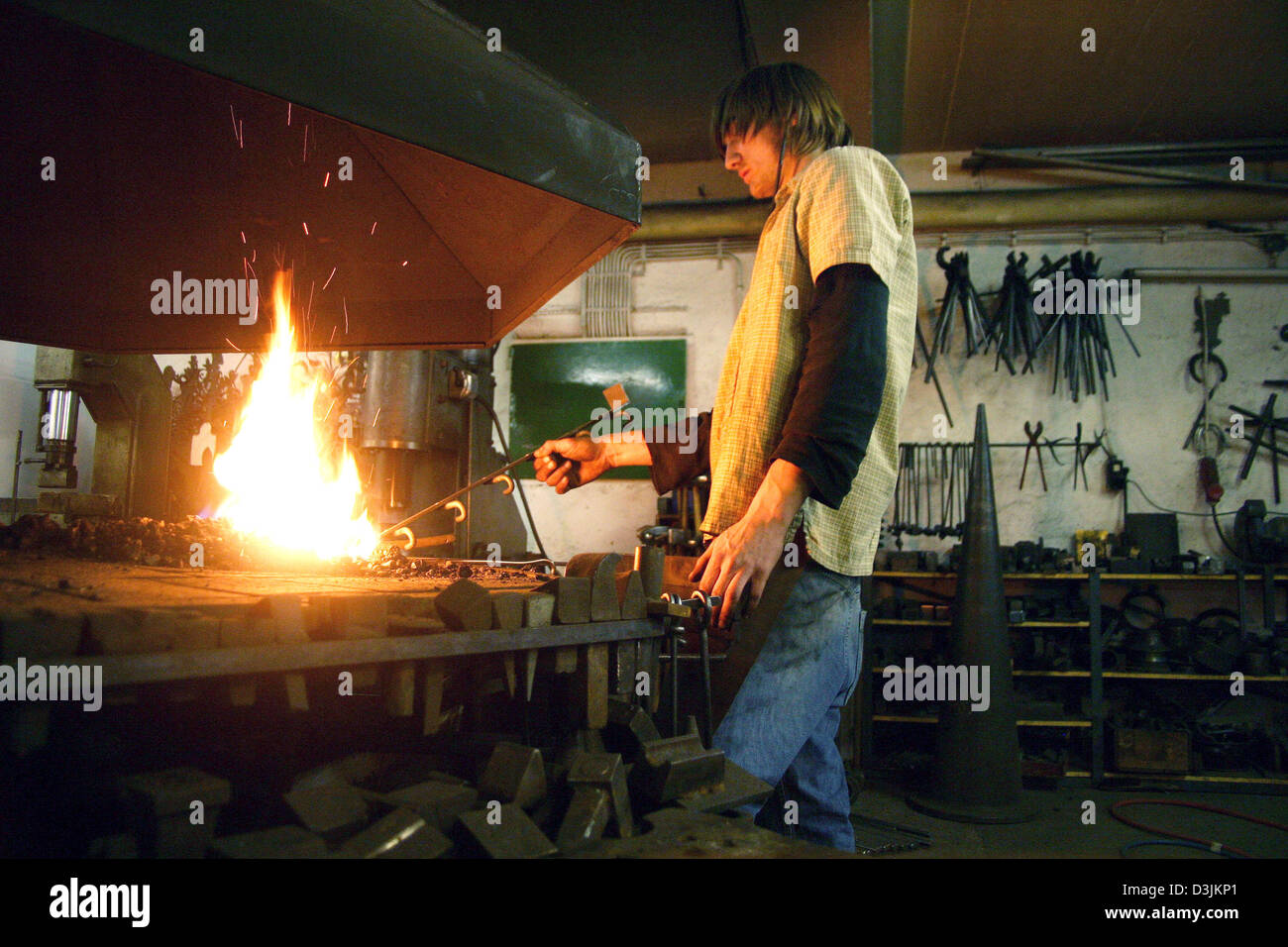 (dpa) - A blacksmith works at the smith's hearth in the Jenauth/Luest ...
