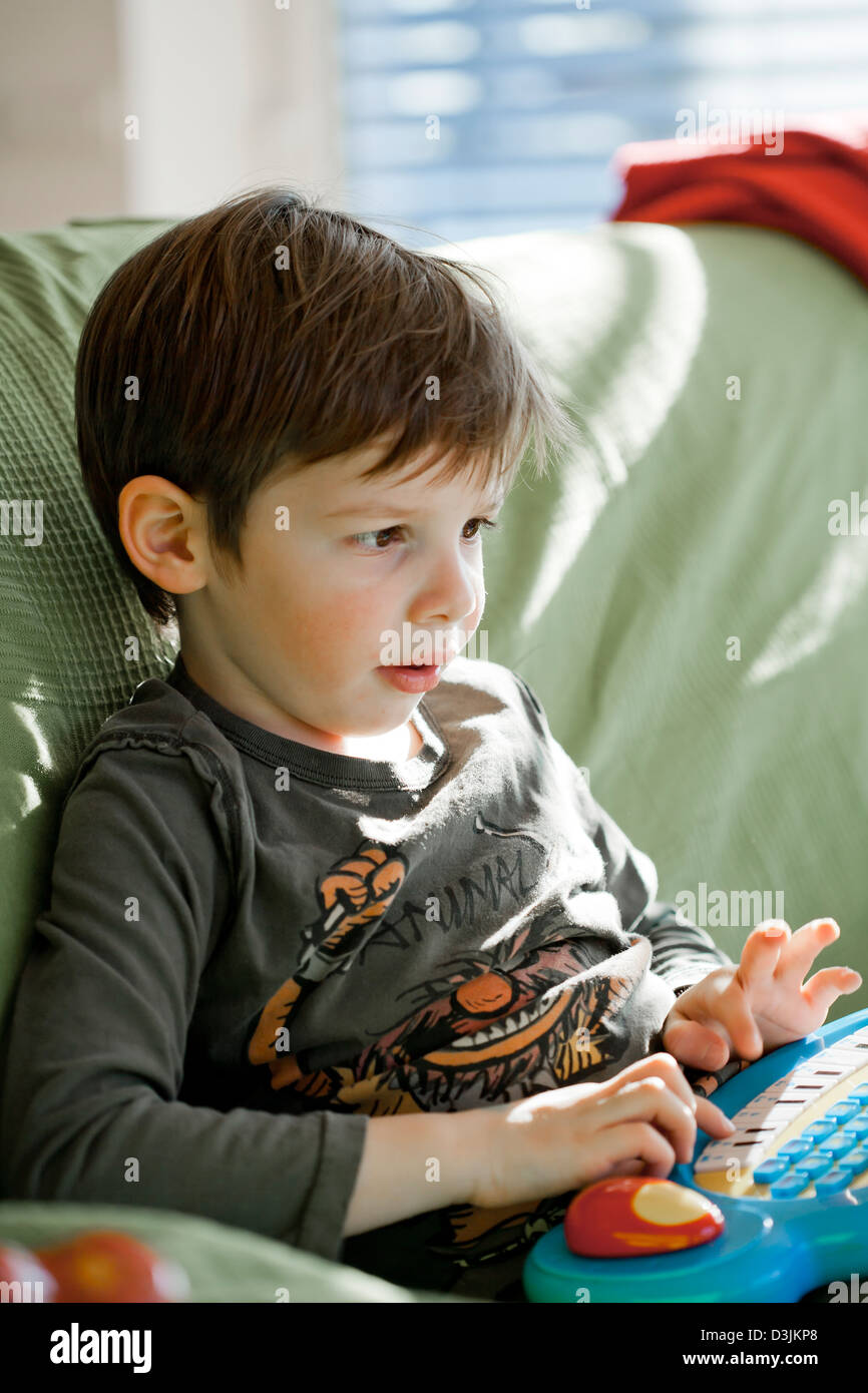 Boy playing with a toy computer Stock Photo - Alamy