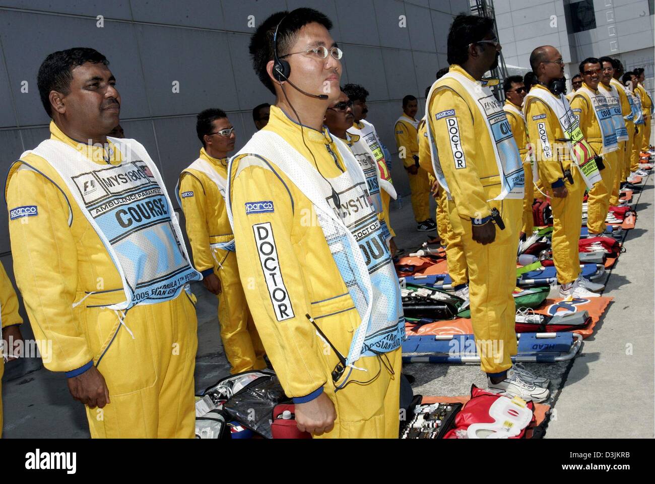 (dpa) - Race doctors line up during a health screening at the Malaysian ...