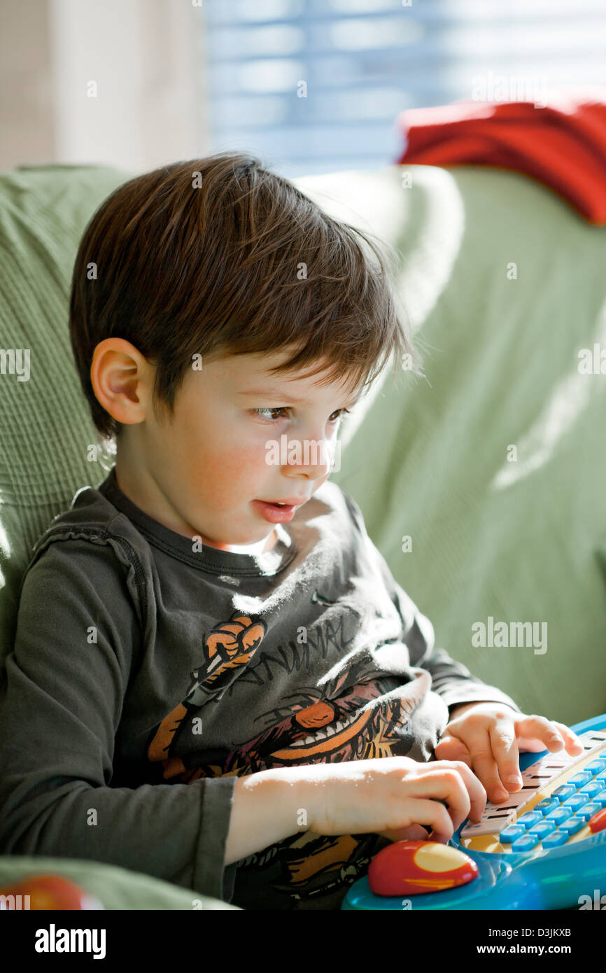 Boy playing with a toy computer Stock Photo - Alamy
