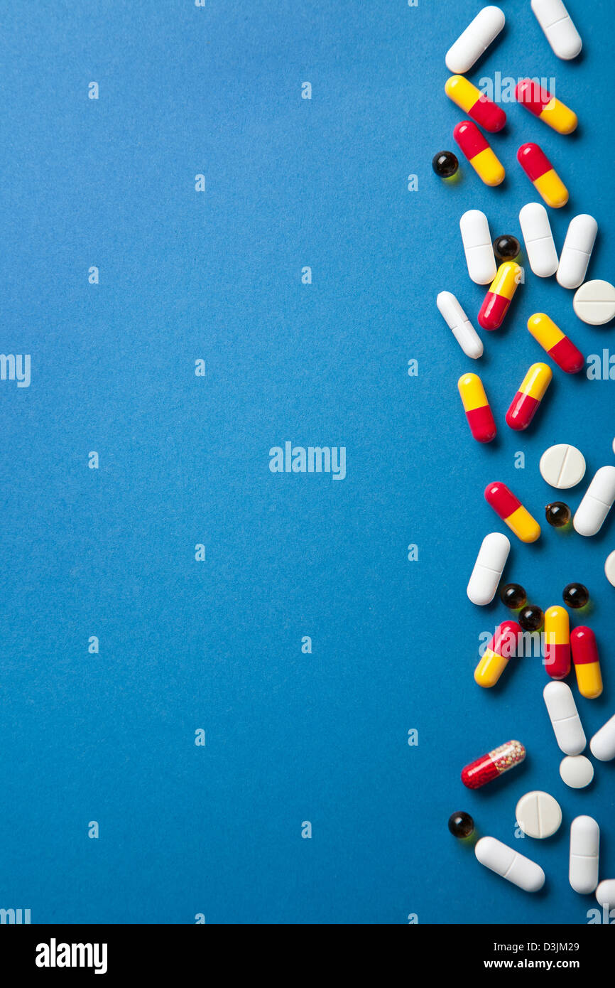 pills border over blue Stock Photo - Alamy