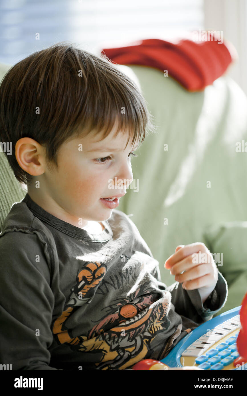 Boy playing with a toy computer Stock Photo - Alamy