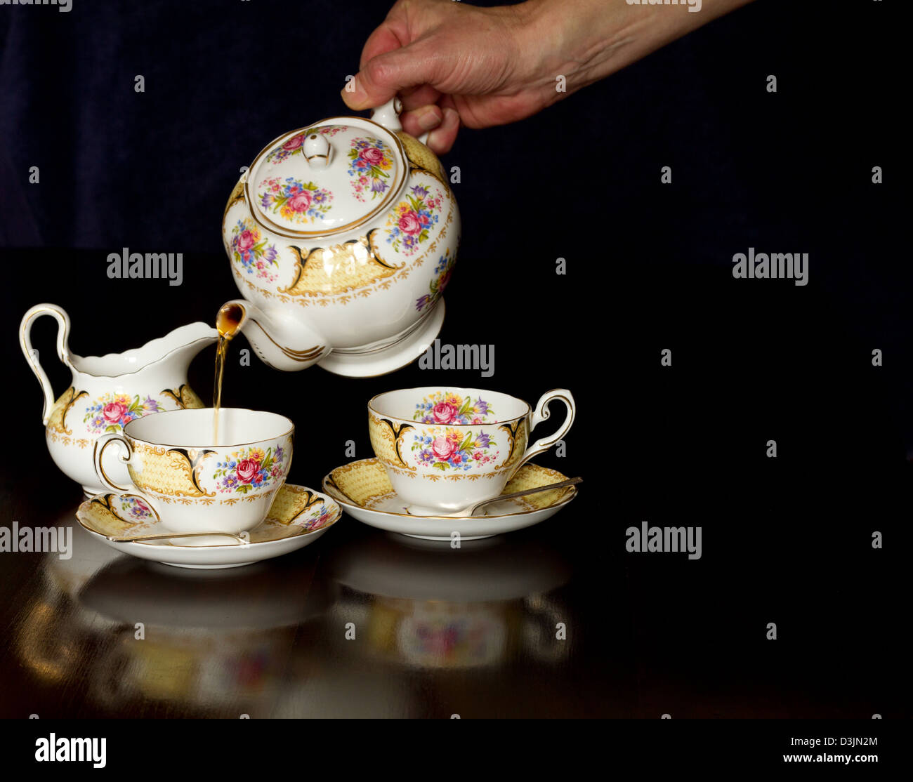 Pouring tea for two Stock Photo - Alamy