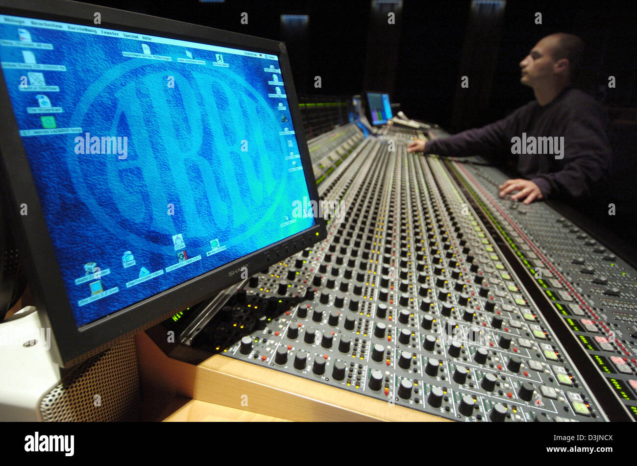 (dpa) - A technician pictured in a studio with mixer and film screen at ...