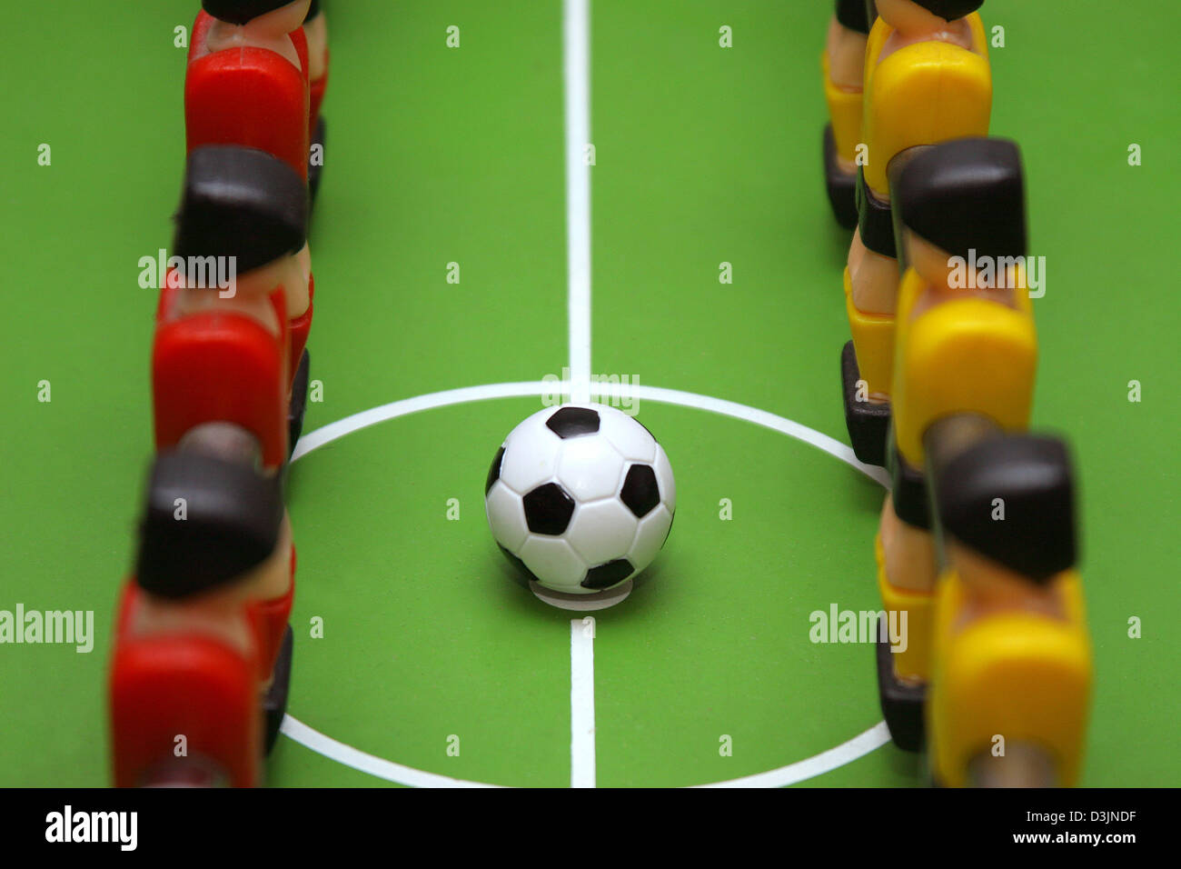 (dpa) - A small soccer ball lies on the kick off spot in a table soccer ...