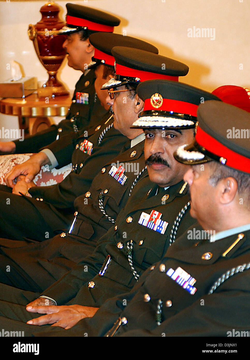 (dpa) - Members of Bahrain's police force sit next to each other as ...