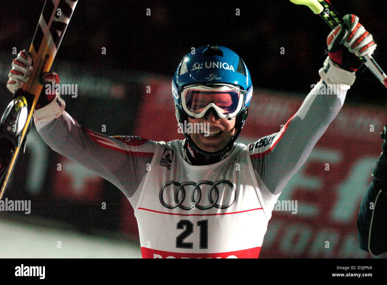(dpa) - Austrian skier Benjamin Raich raises his arms and cheers as he ...