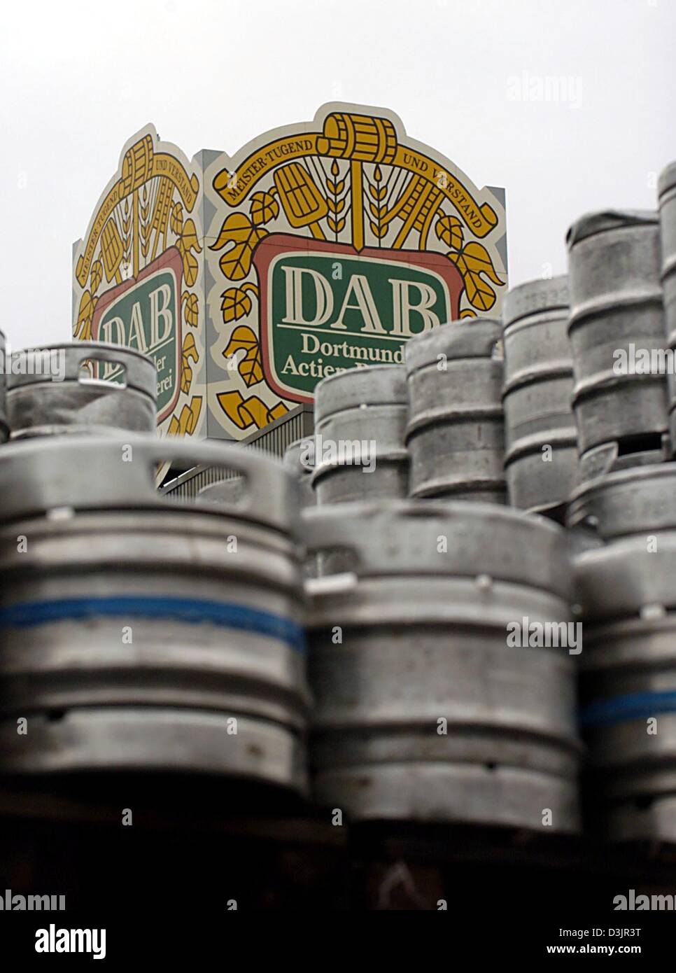 (dpa) - Beer barrels stand in front of the logo of the 'Dortmund Actien ...