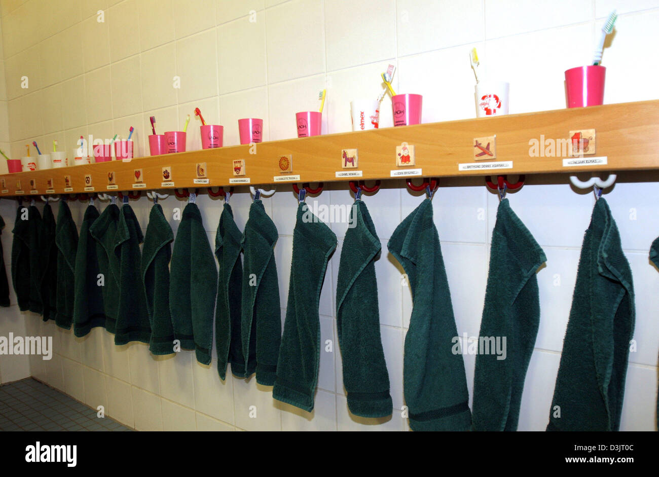 (dpa) - Children's towels hang on a shelf featuring name tags and their ...