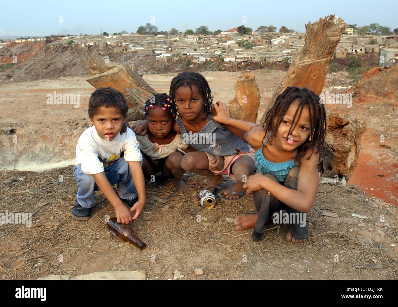 (dpa) - Boys and girls sitting on a hill above one of the slums of ...