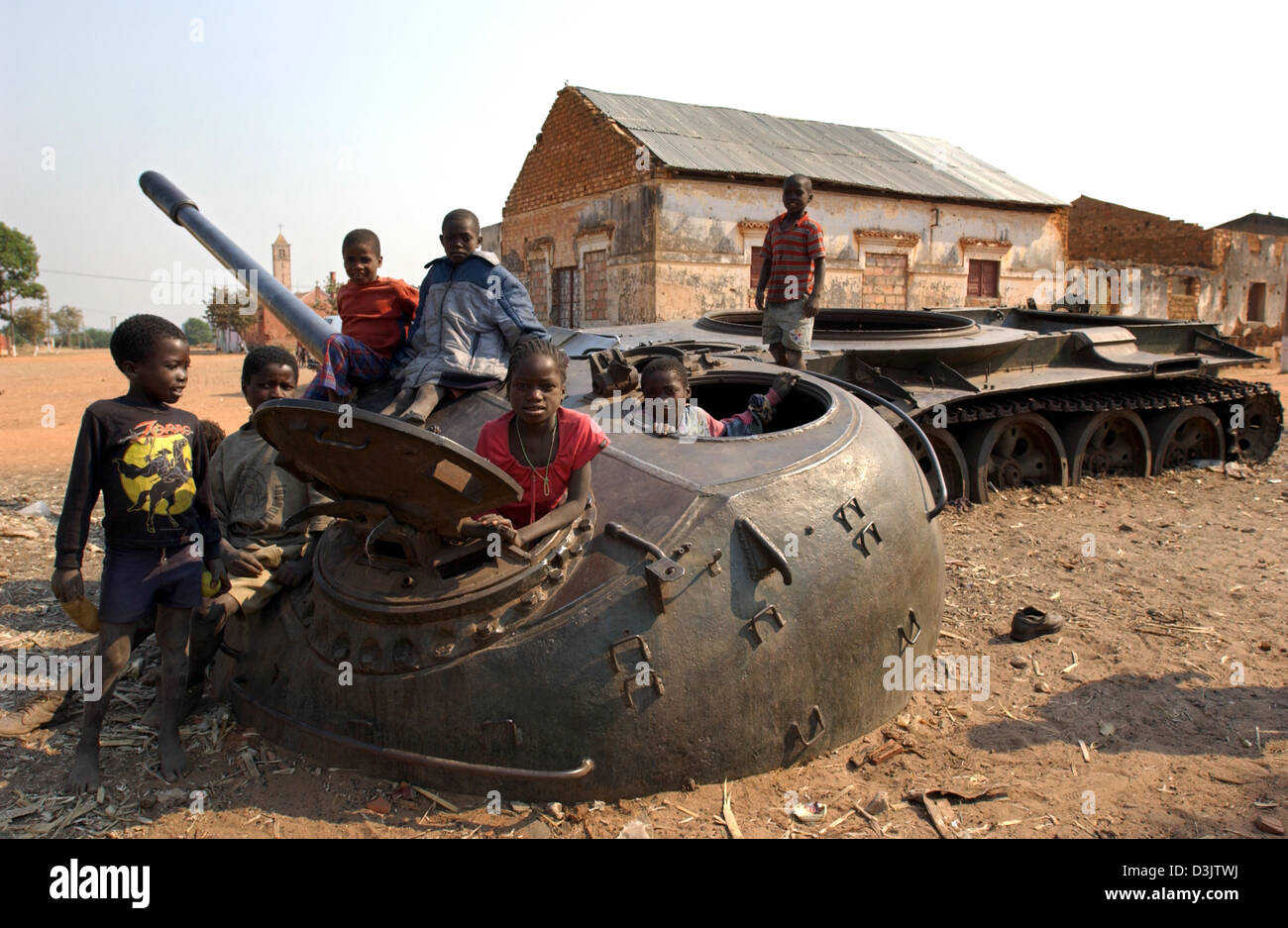 (dpa) - Children play on a destroyed tank in Kunje, a town near the ...